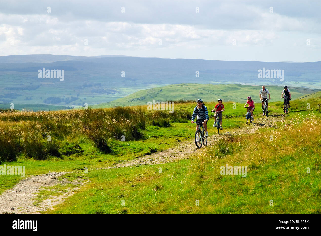 Family group on mountain bikes on Stockdale Lane near Settle, part of ...
