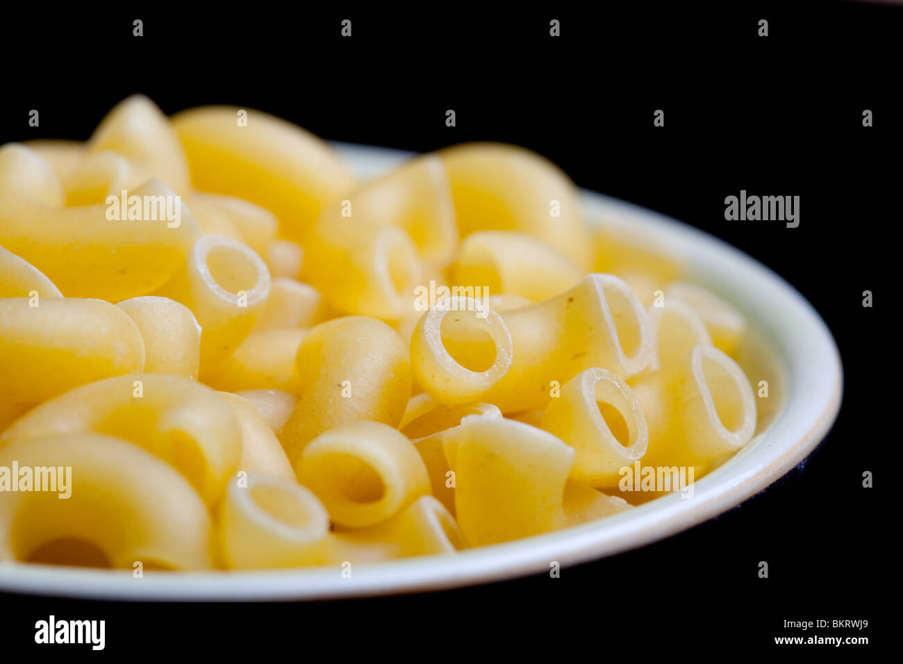 Dried macaroni pasta in a small bowl Stock Photo - Alamy