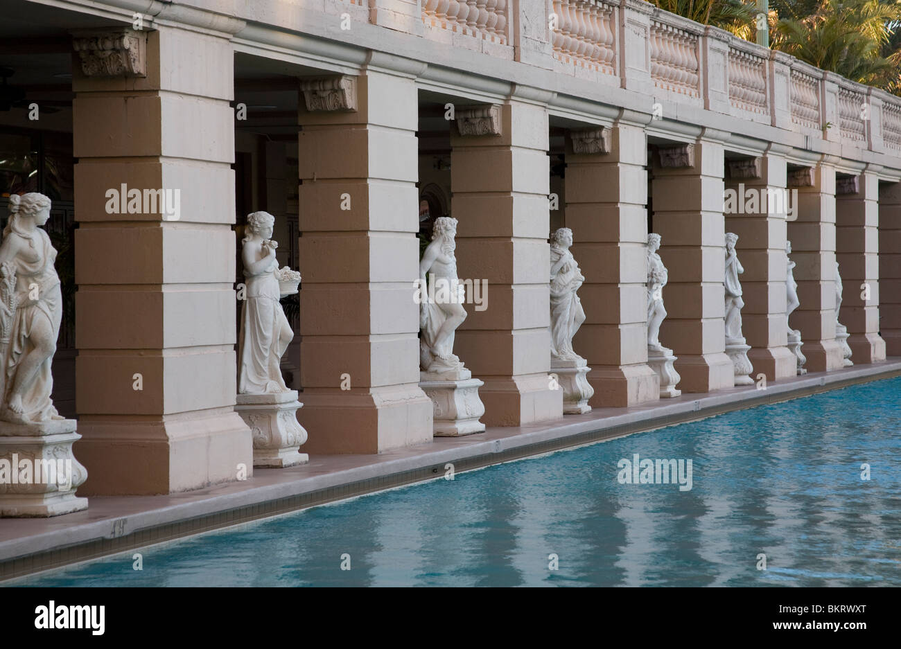 Classical statues line the edge of the largest hotel pool in the ...