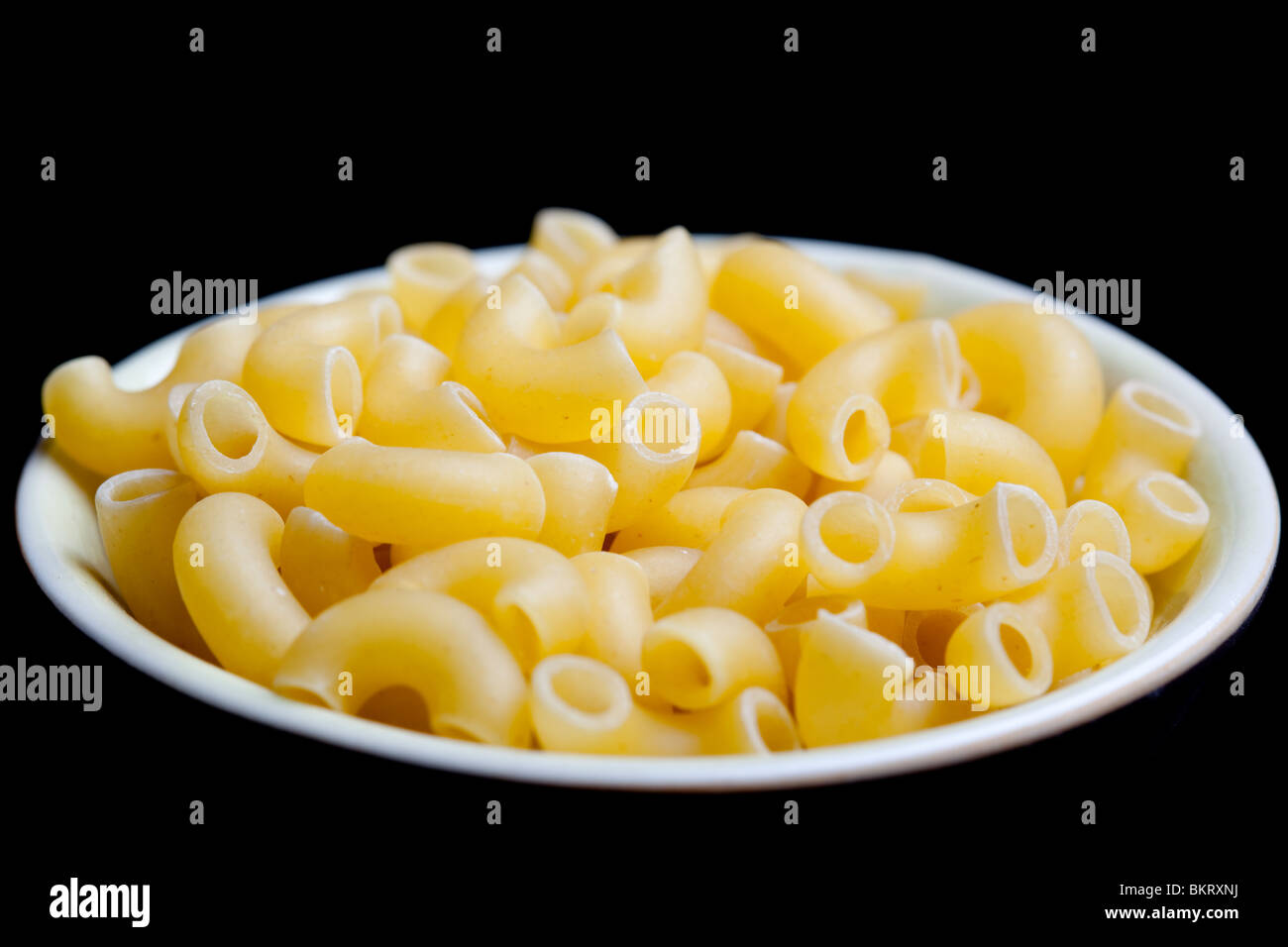 Dried macaroni pasta in a small bowl Stock Photo - Alamy