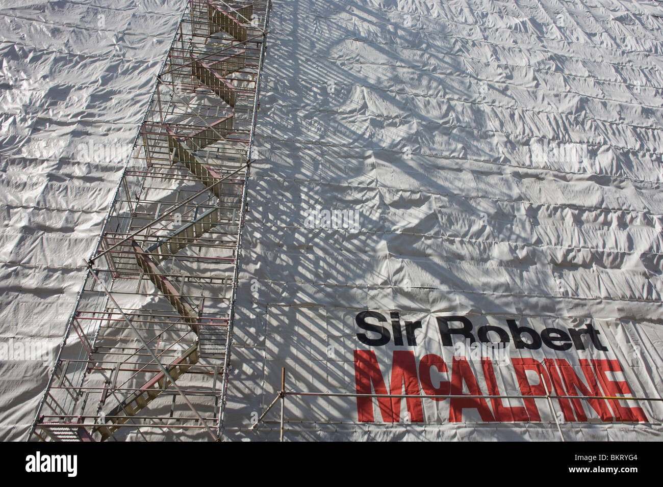 Protective sheeting surrounds tall building project by McAlpine in ...