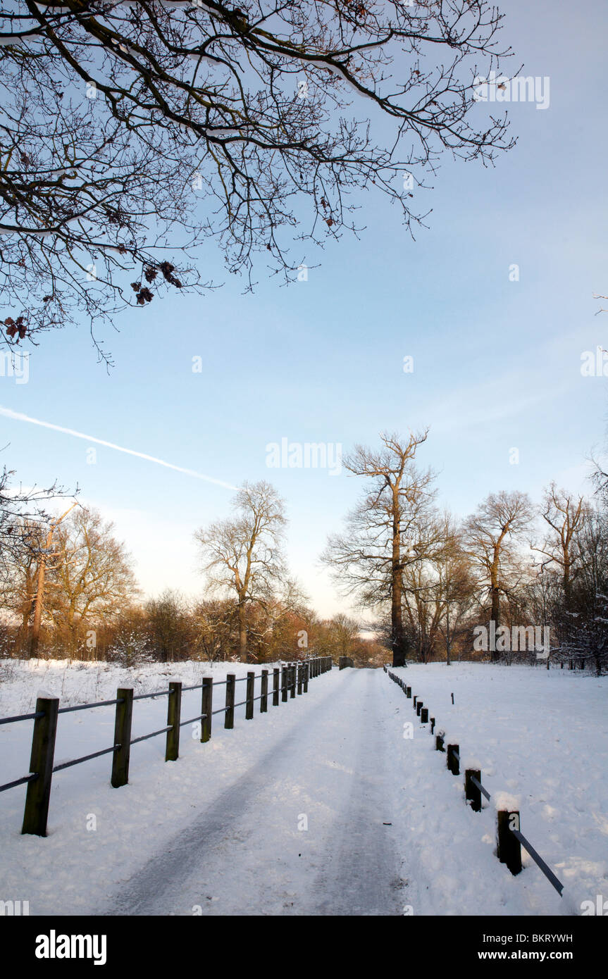 A footpath covered in snow with a fence Stock Photo - Alamy