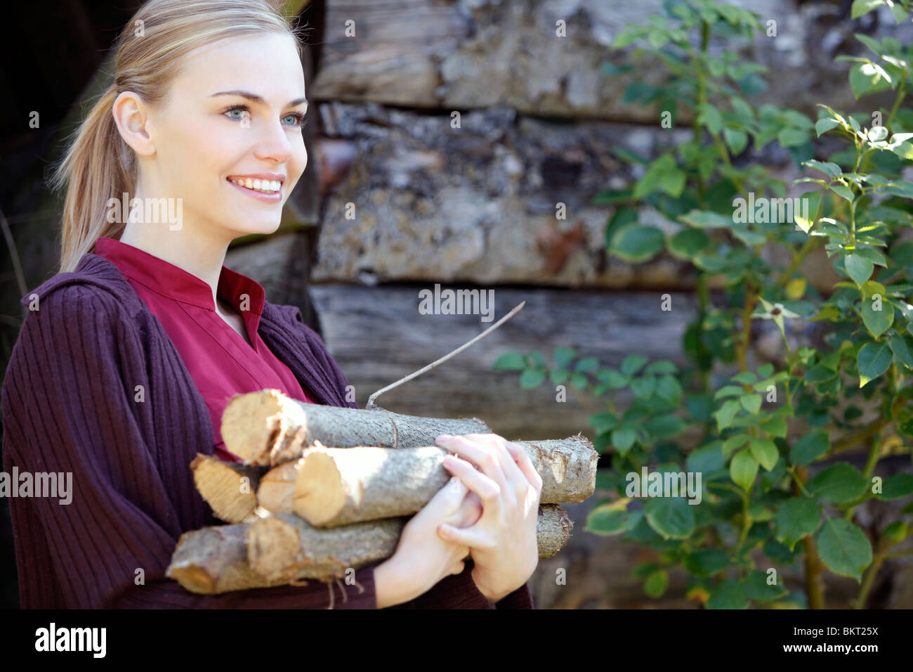 Girl with wood Stock Photo - Alamy