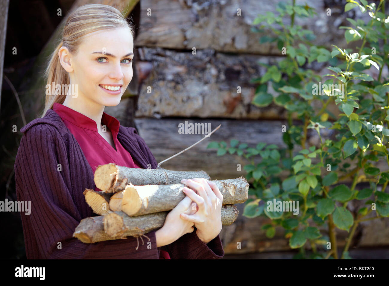 Girl with wood Stock Photo - Alamy
