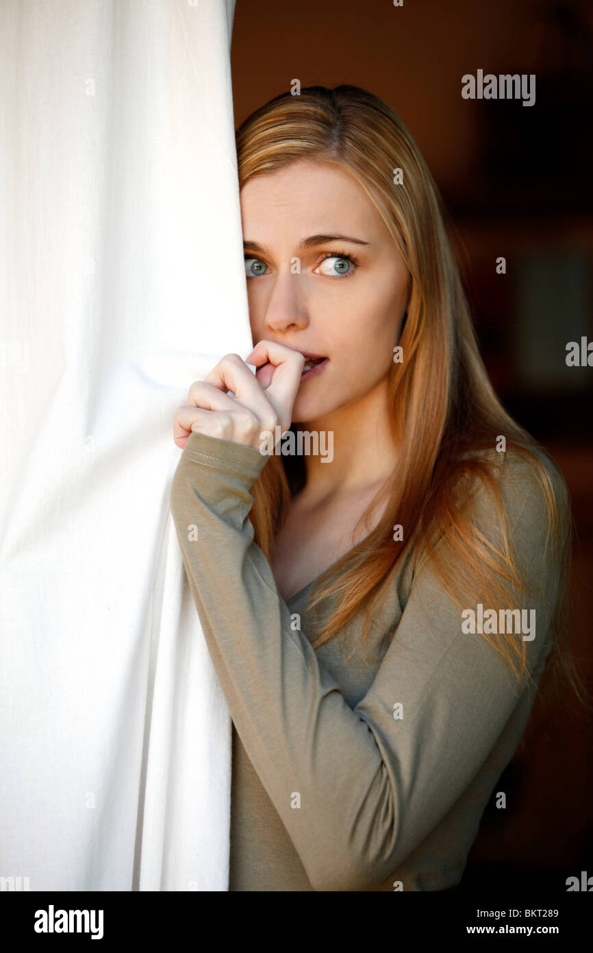 frightened girl at the window Stock Photo - Alamy