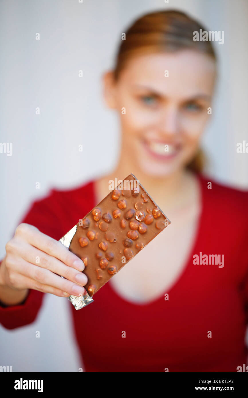 young woman eating chocolate Stock Photo - Alamy