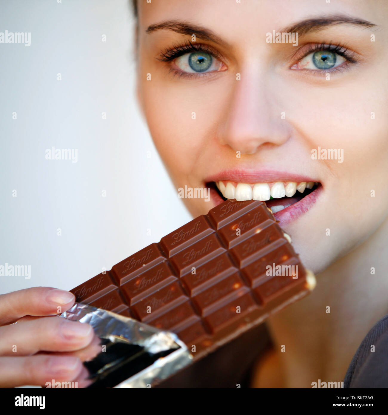 young woman eating chocolate Stock Photo - Alamy