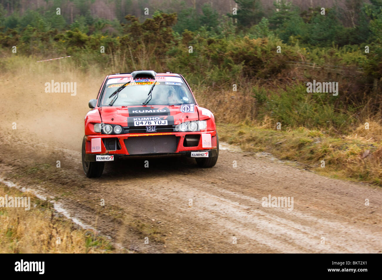 Rally Car in a bend with mud flying Stock Photo - Alamy