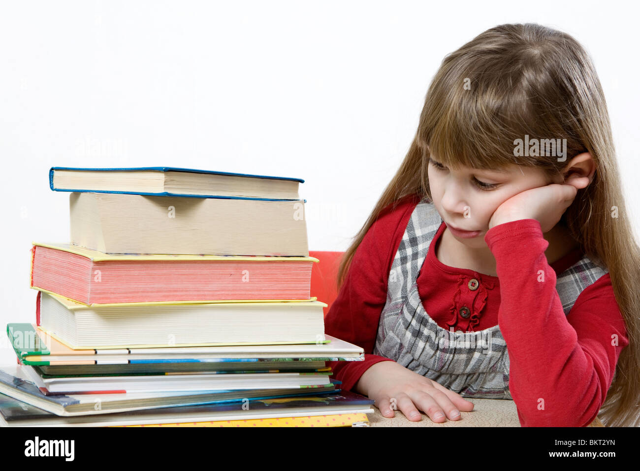 Is it possible to read all these books? little cute sad girl with a ...