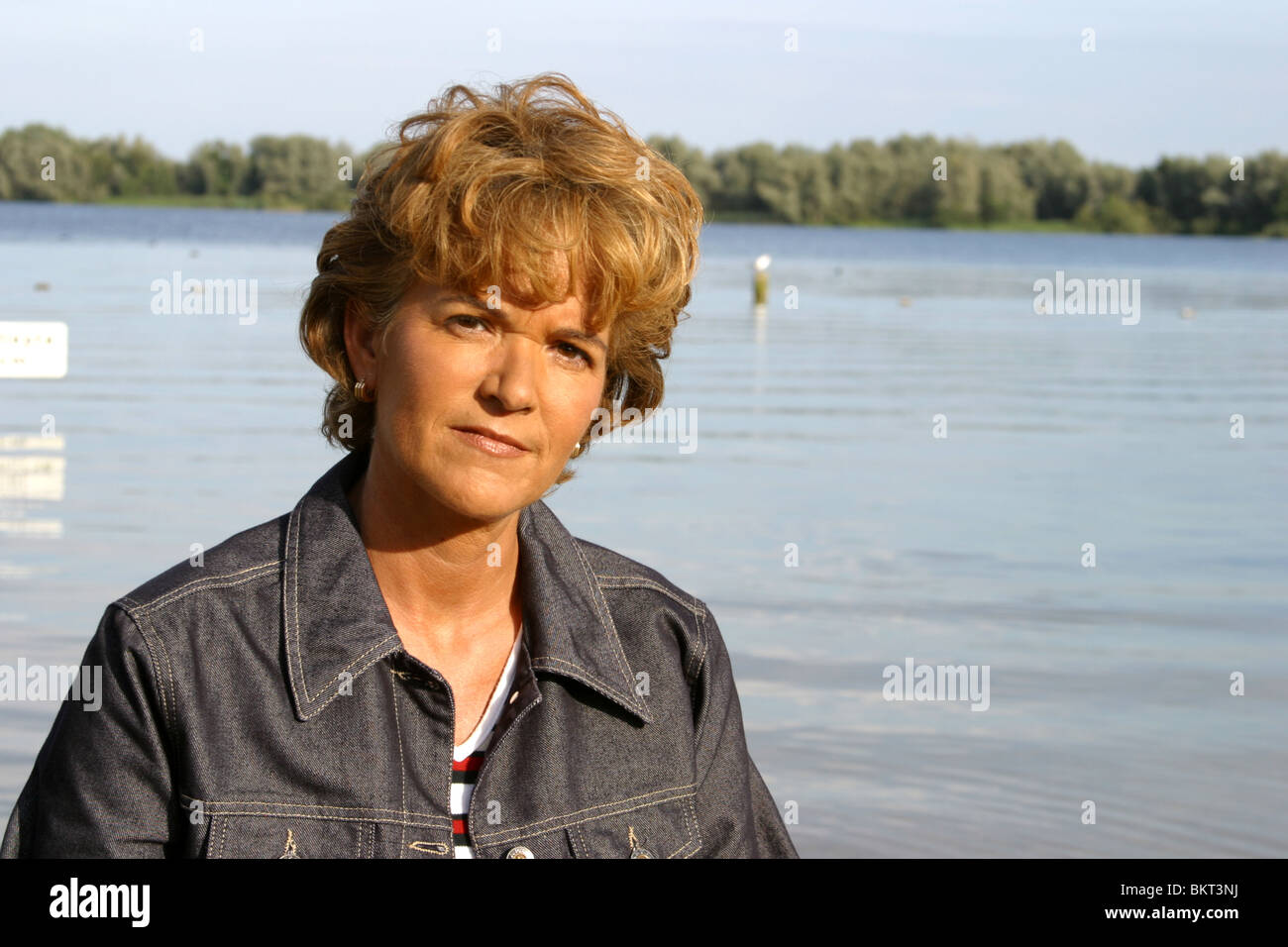 Woman 40s natural woman looking at camera serious face Stock Photo - Alamy
