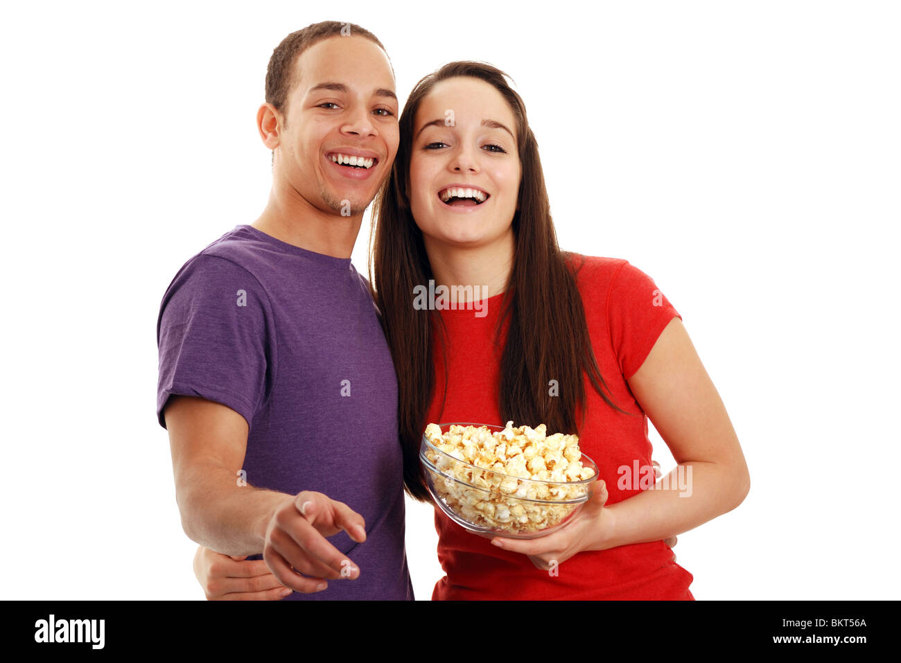 Laughing at a funny film holding popcorn Stock Photo - Alamy