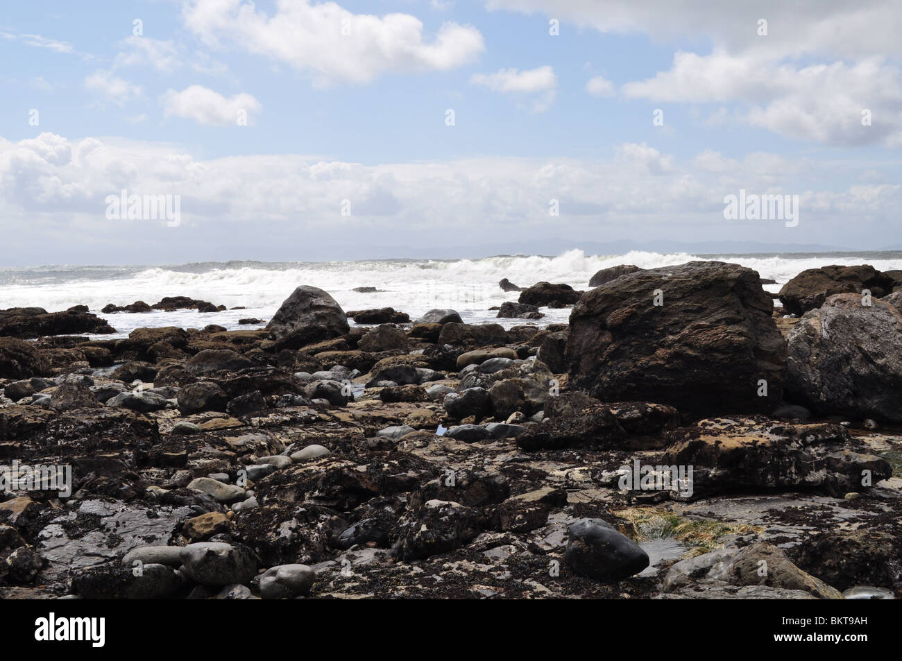 Ocean rolling in After low tide Stock Photo - Alamy