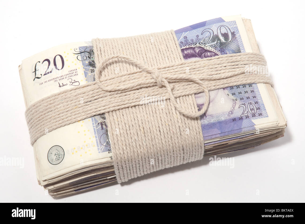 Overhead shot of bundle of twenty pound notes bound with string Stock ...