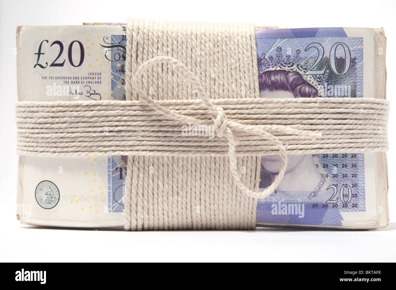 Bundle of twenty pound notes tied up with string Stock Photo - Alamy
