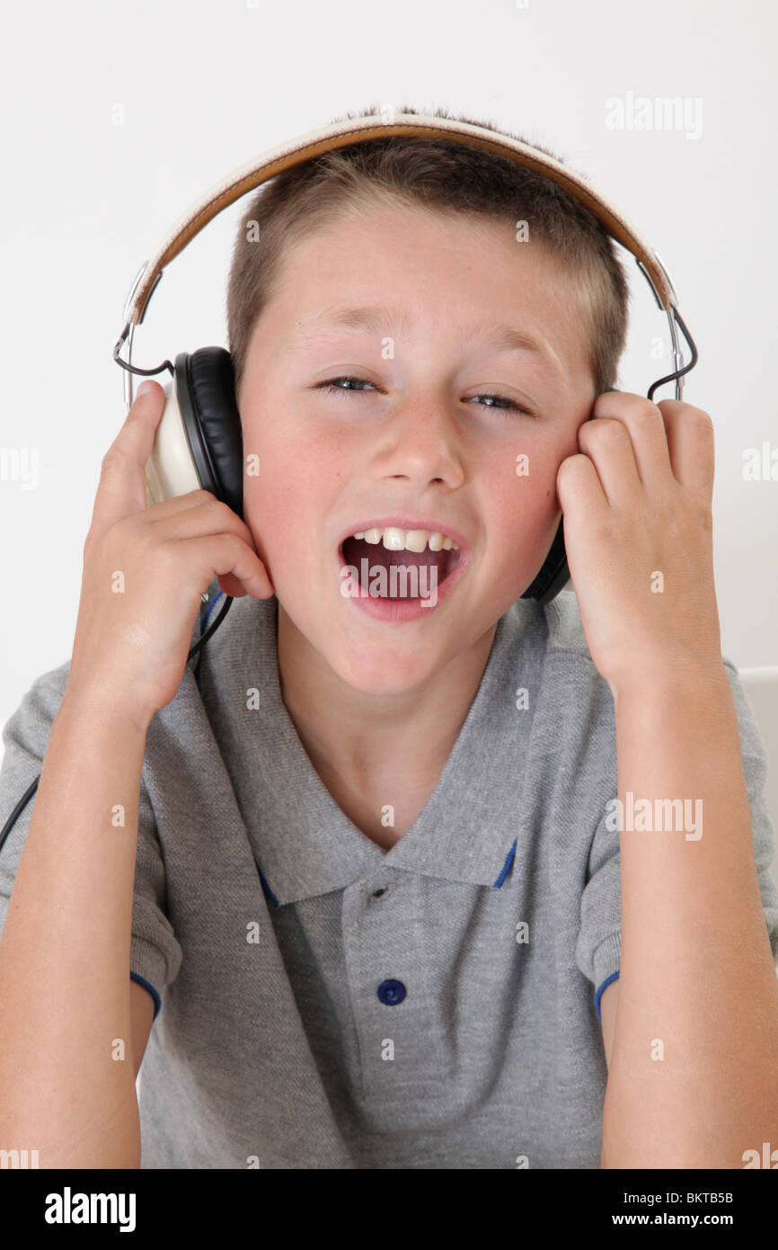 Young boy wearing headphones listening to music Stock Photo - Alamy