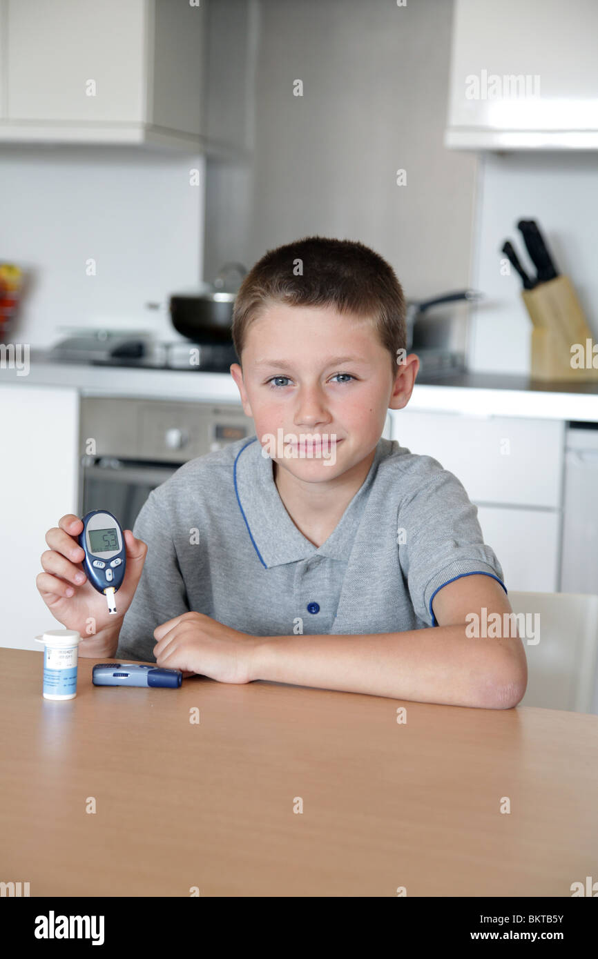 Young boy doing a blood glucose test Stock Photo - Alamy