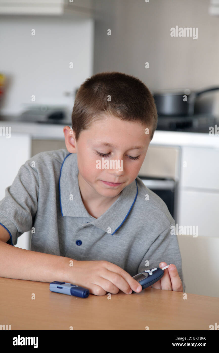 Young boy carrying out blood glucose test Stock Photo - Alamy