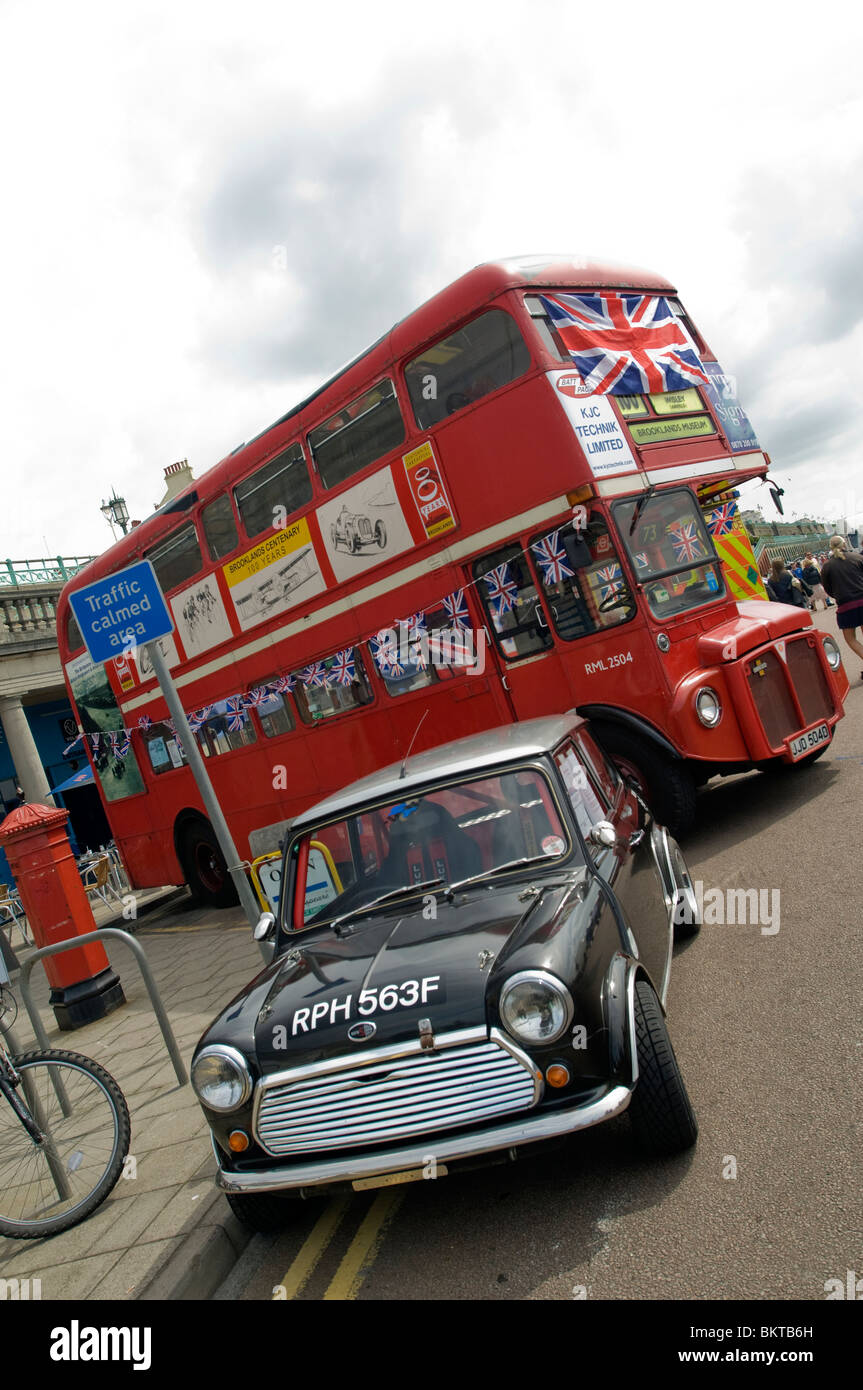 An Austin Mini parked in-front of a London Routemaster Bus Stock Photo ...