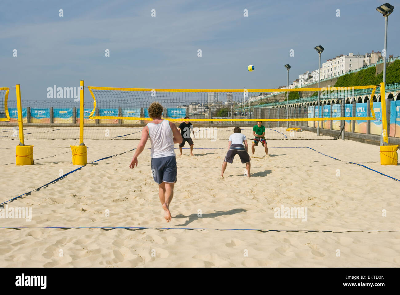 People playing beach volleyball on seaside sand on Brighton seafront in ...