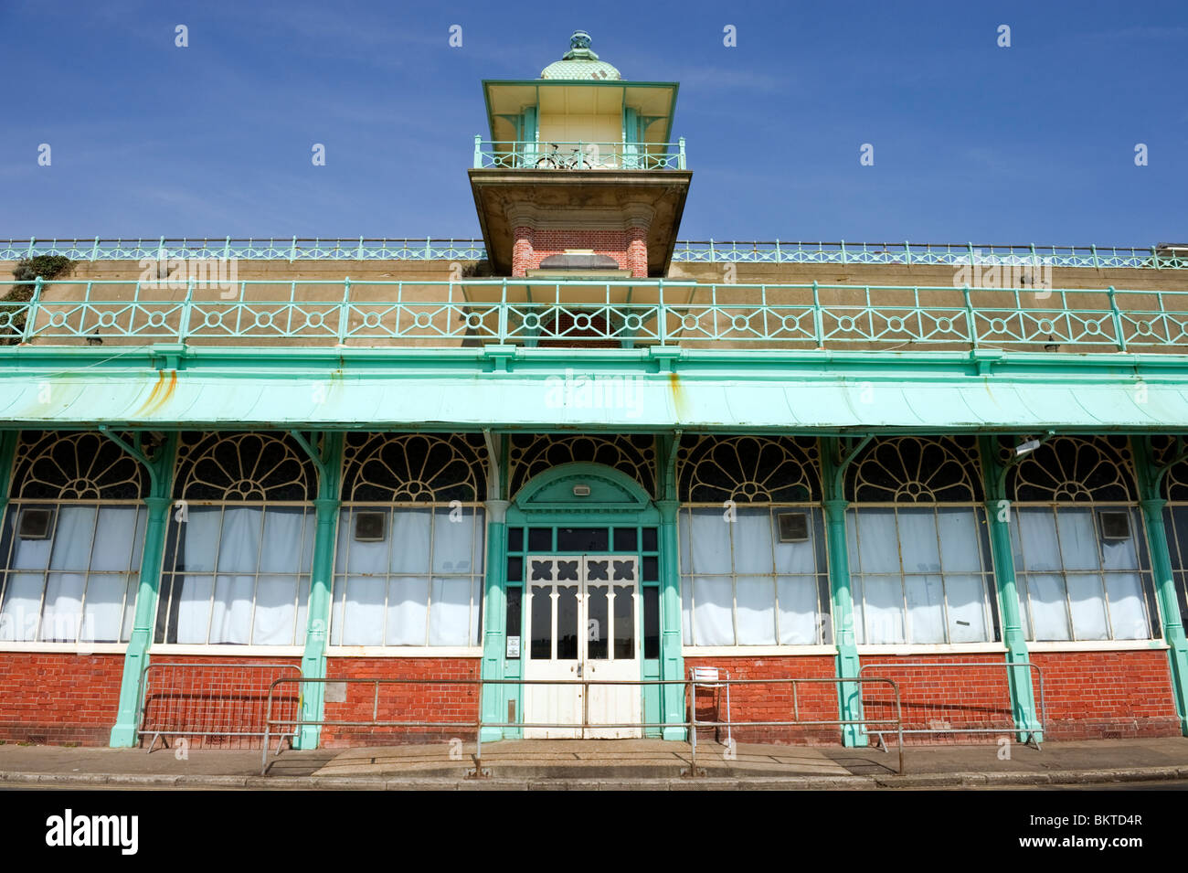 A historical Victorian building on Brighton seafront under a clear blue ...