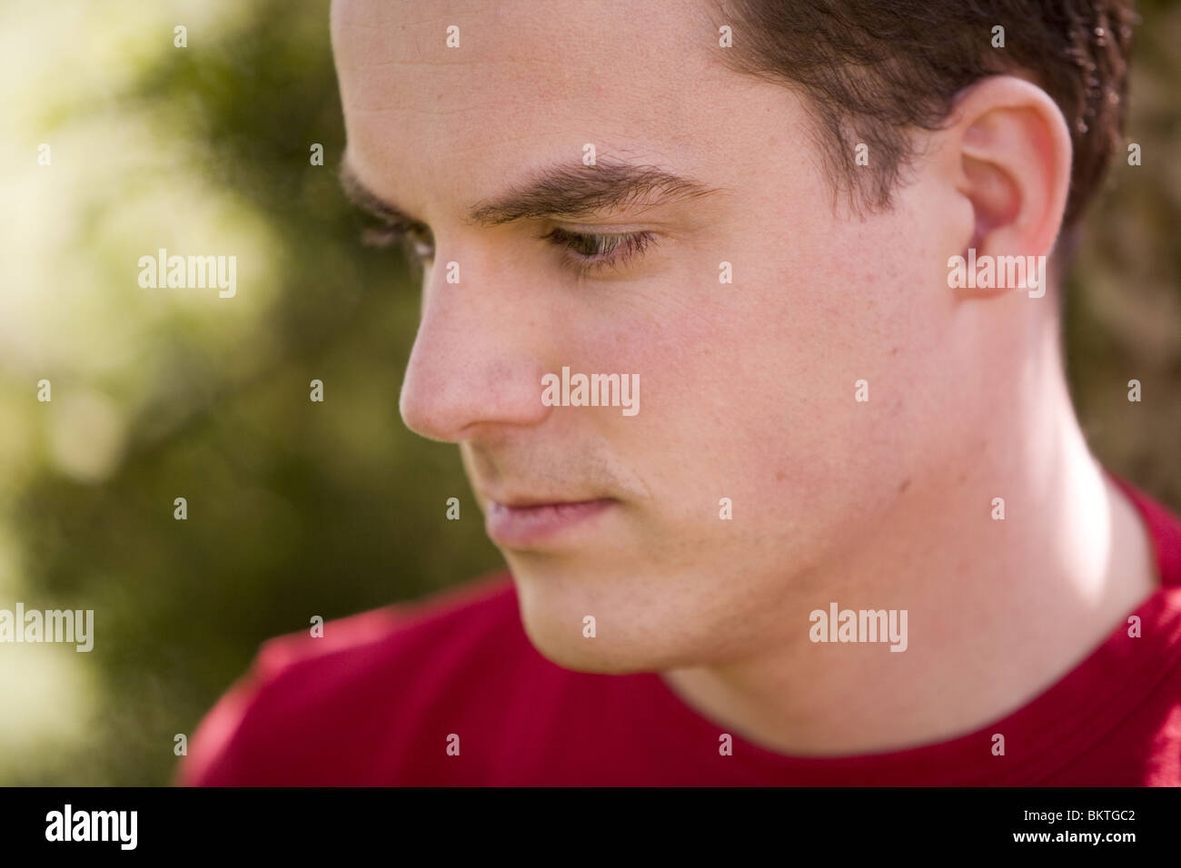 Young man serious face Stock Photo - Alamy