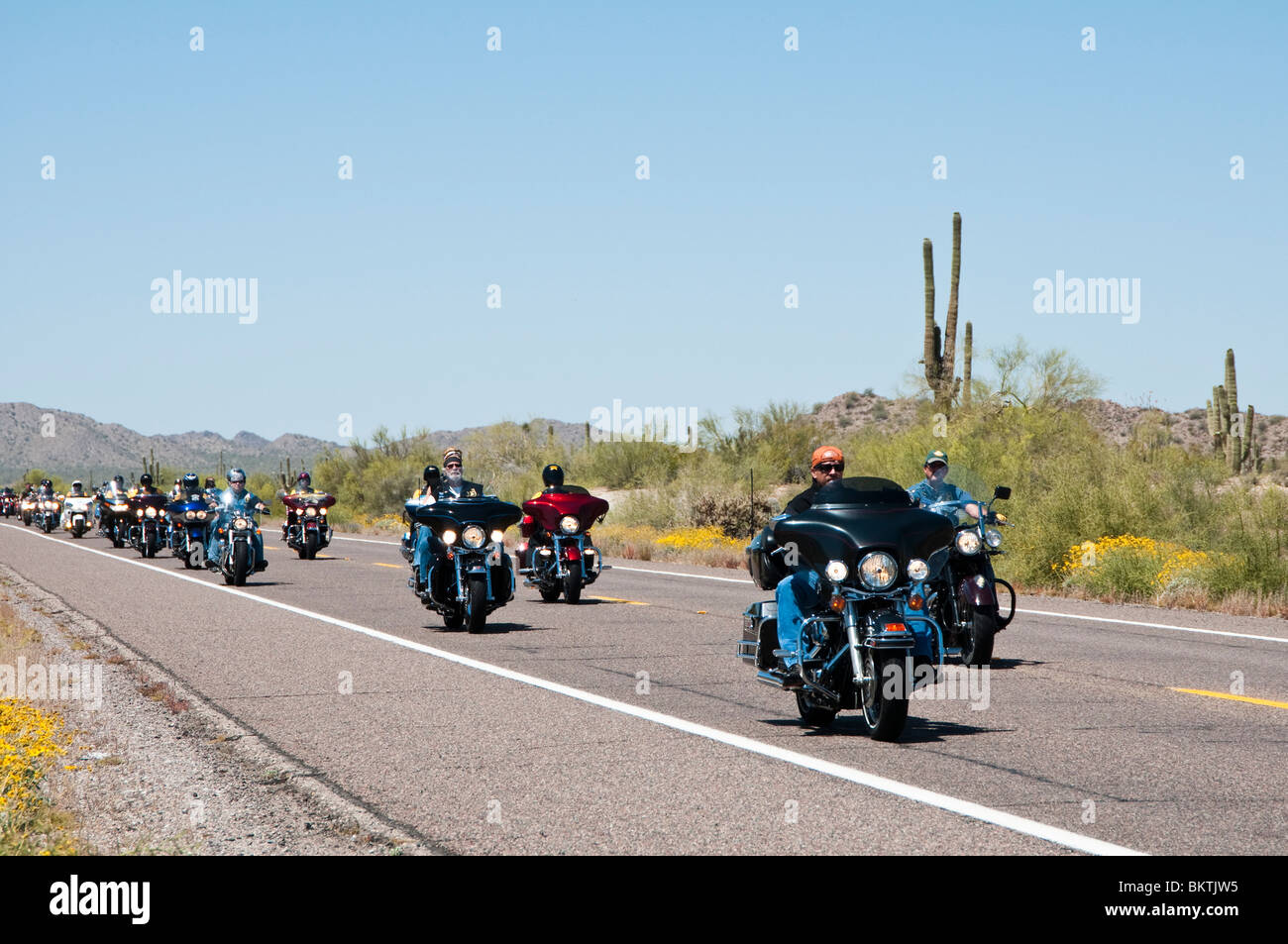 motorcycles travel on a road through the desert Stock Photo - Alamy