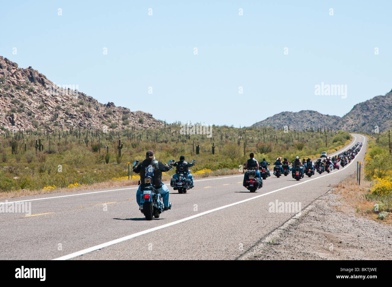 motorcycles travel on a road through the desert Stock Photo - Alamy