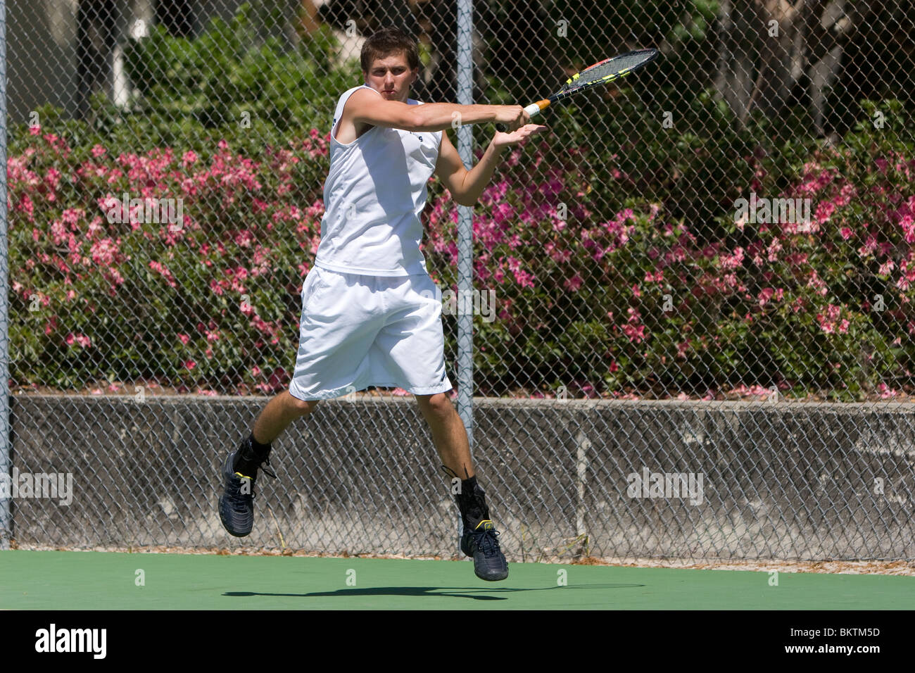 Male tennis player after returning a ball Stock Photo - Alamy