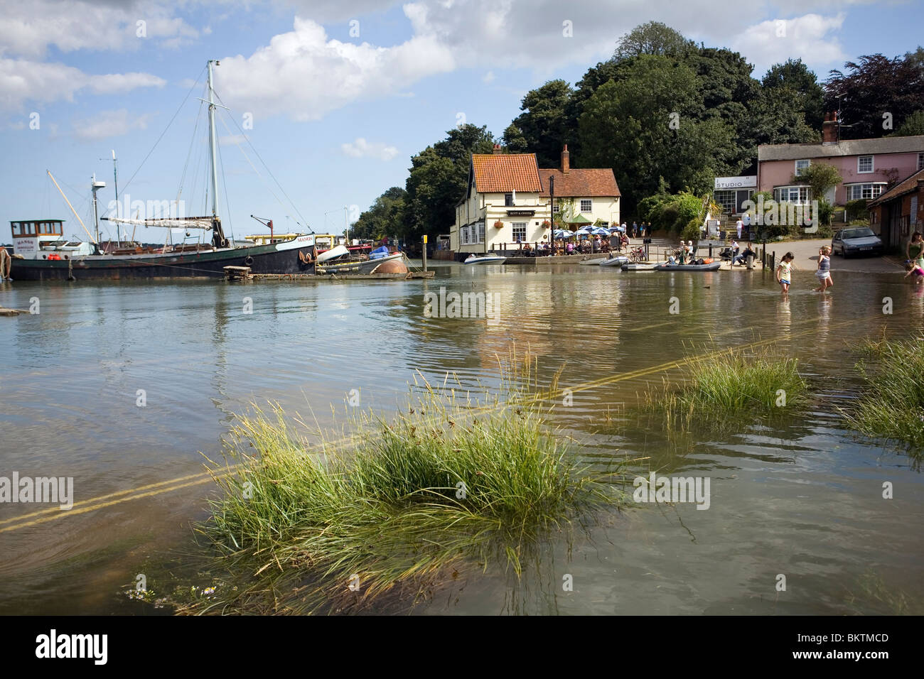 The harbour at Pin Mill with boats and The Butt and Oyster pub on the ...