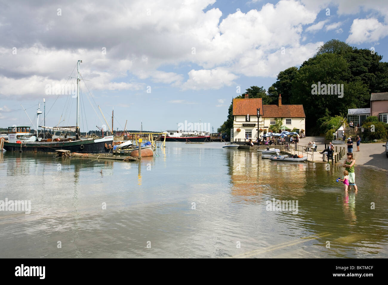 The harbour at Pin Mill with boats and The Butt and Oyster pub on the ...