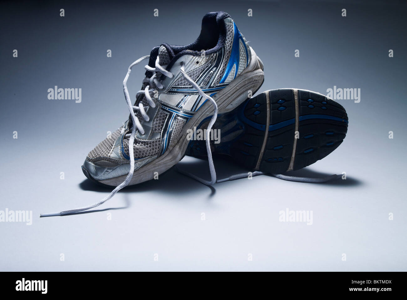 trainers, laces untied after a run Stock Photo - Alamy