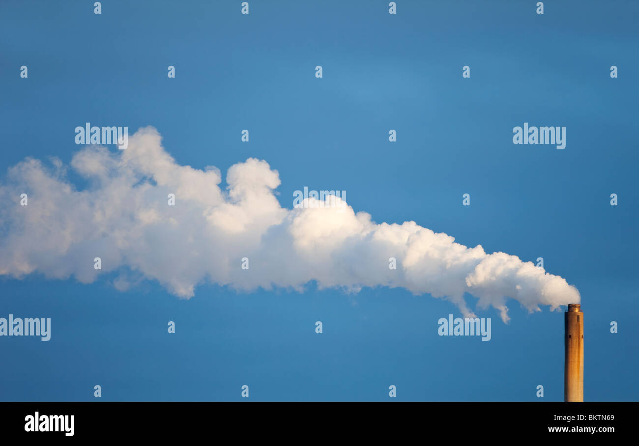 Smoke stack spewing white smoke to blue sky , Finland Stock Photo - Alamy