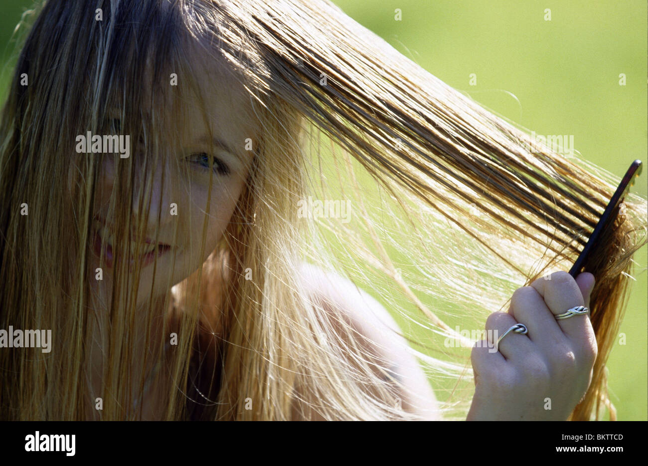 Woman hair combing Stock Photo - Alamy