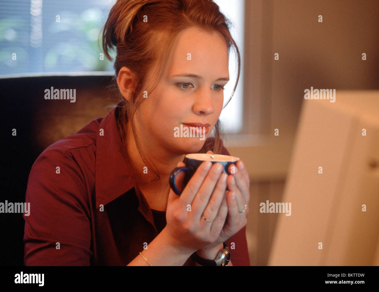 Coffee drinking at work behind computer screen Stock Photo - Alamy