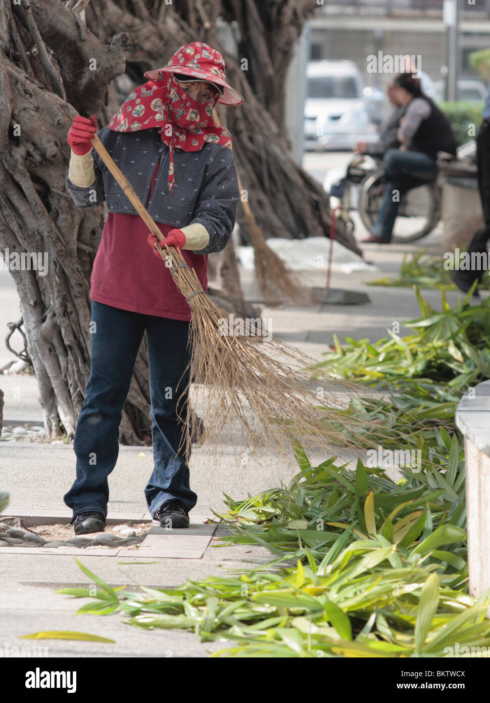 Female worker cleans street Stock Photo - Alamy