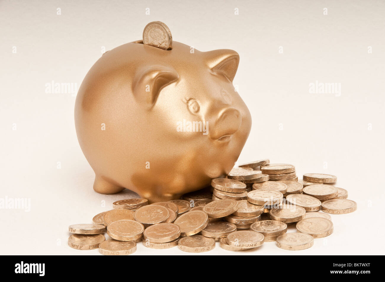 Child's piggy bank and pound coins Stock Photo - Alamy