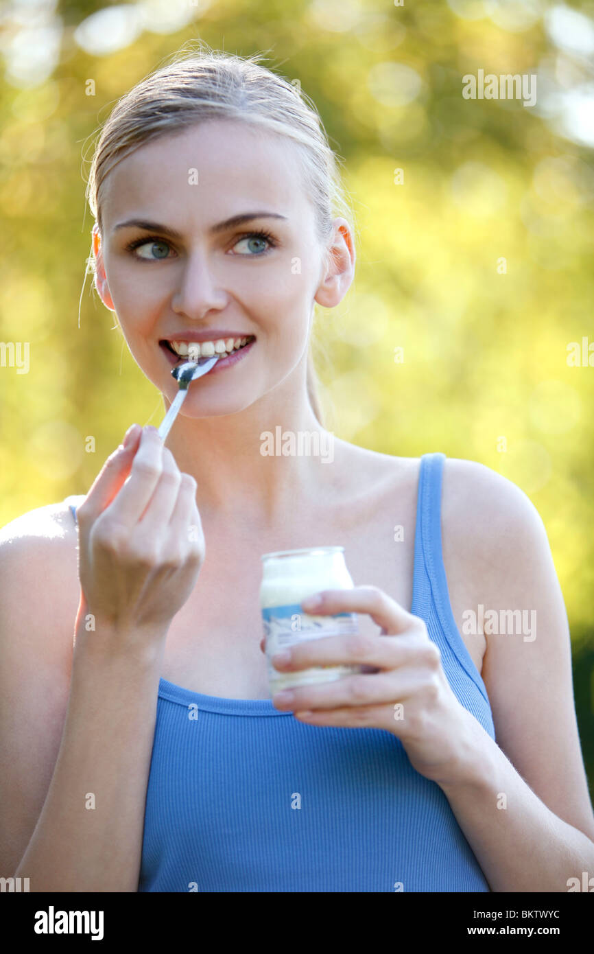 young woman eating yogurt Stock Photo - Alamy