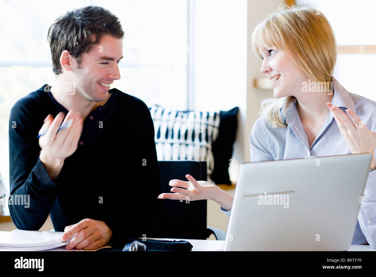 Smiling man and woman by computer Stock Photo - Alamy