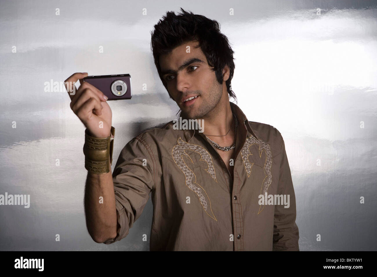 Young man holding mobile phone Stock Photo - Alamy Young man holding mobile phone Stock Photo - Alamy
