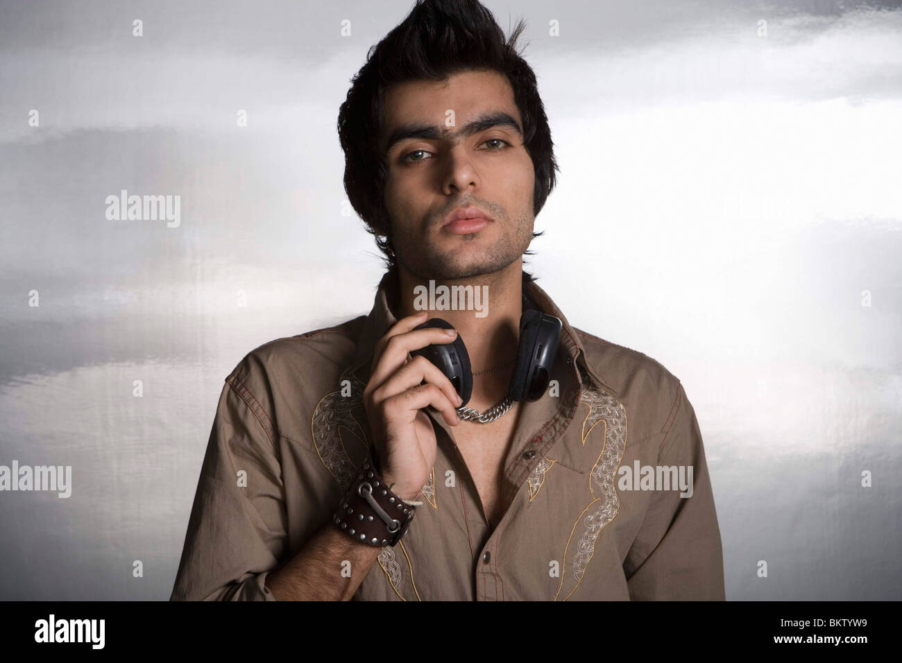 Young man holding headphone, portrait Stock Photo - Alamy