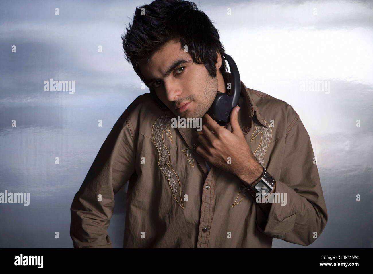 Young man holding headphone, portrait Stock Photo - Alamy