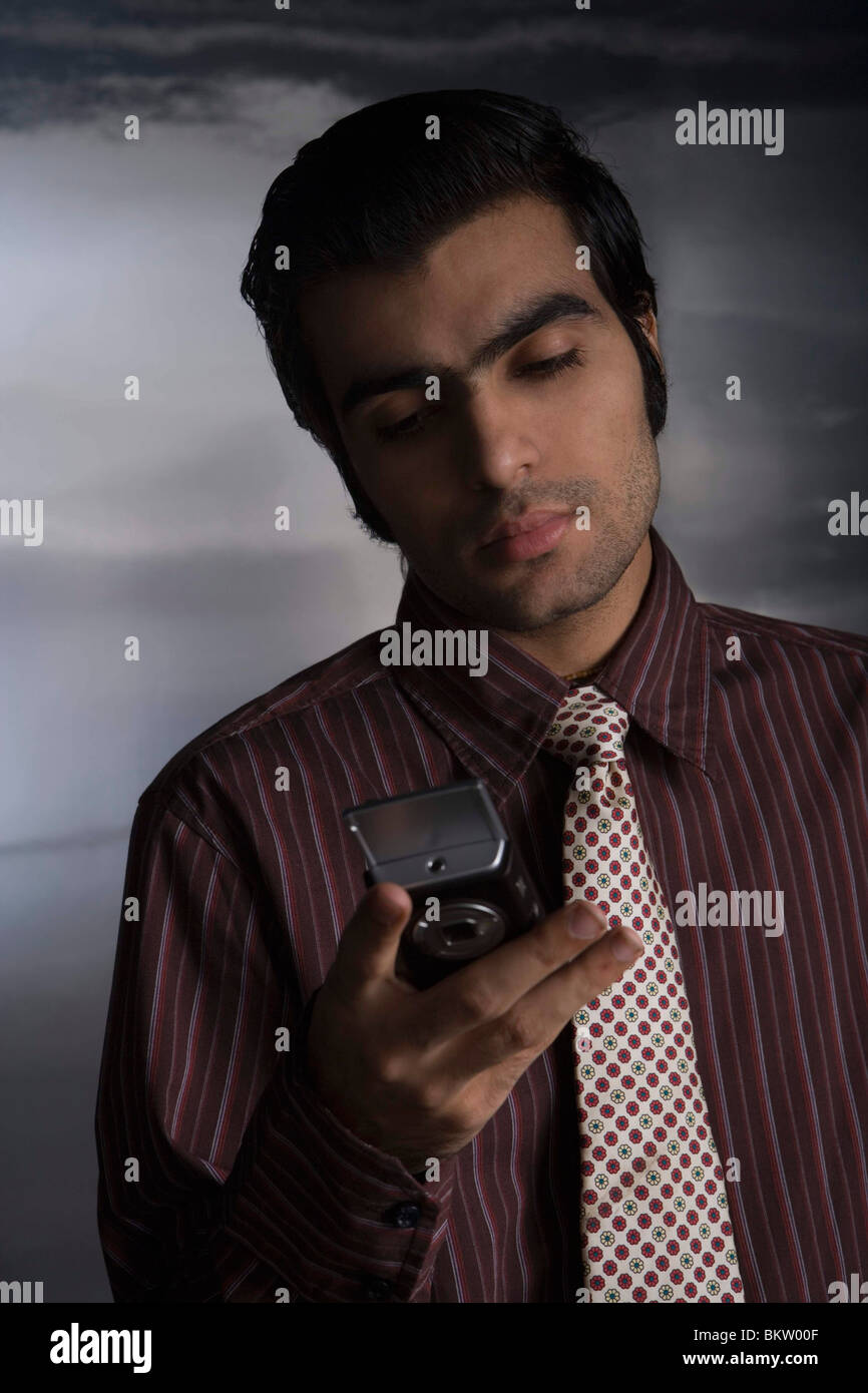 Young man using mobile phone, close-up Stock Photo - Alamy