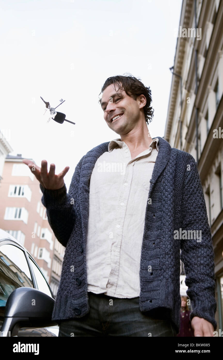 Man throwing keys Stock Photo - Alamy
