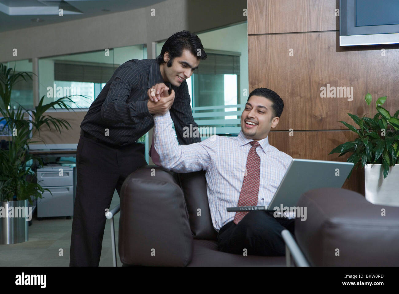 Businessmen greeting each other, smiling Stock Photo - Alamy