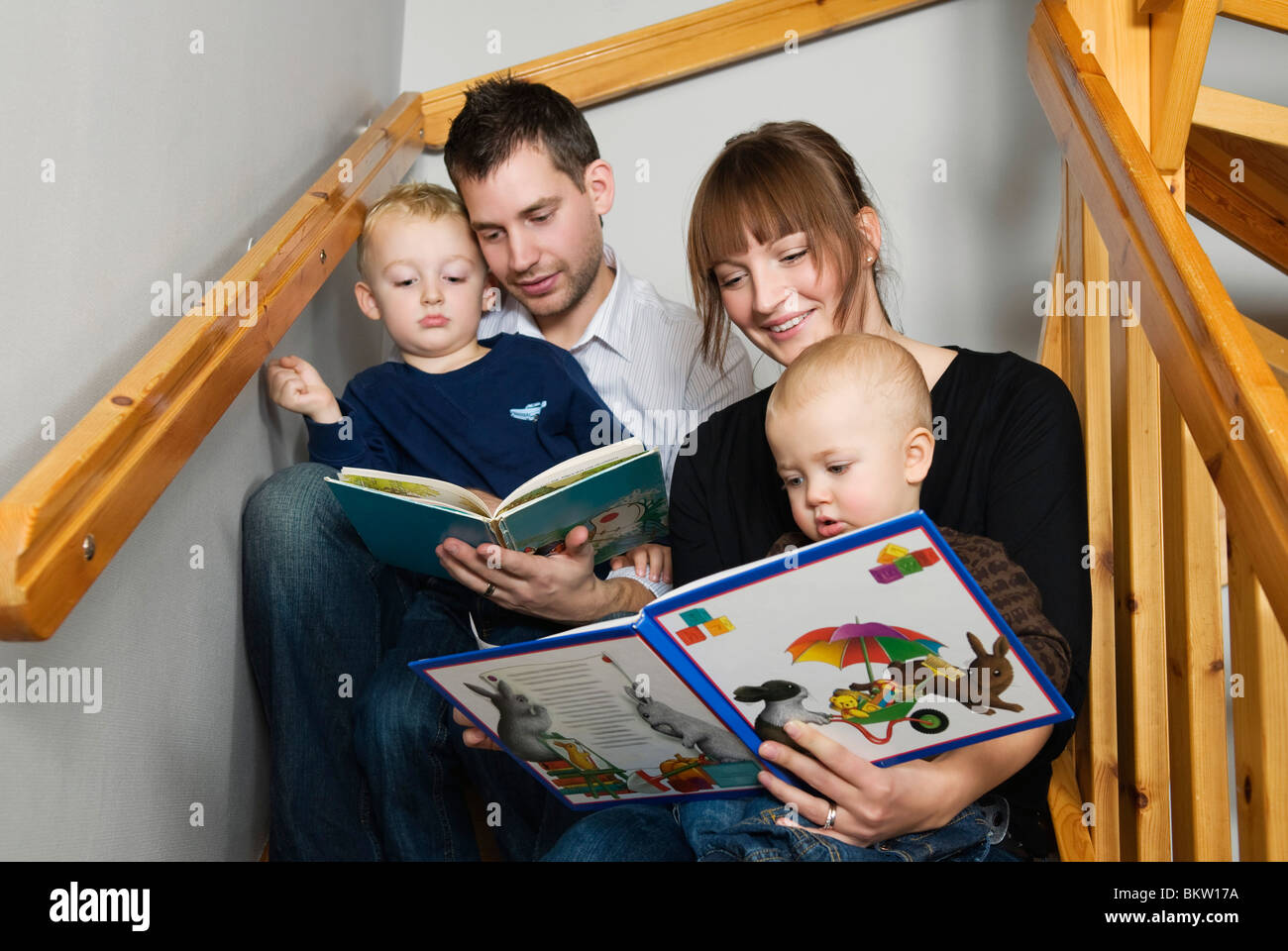 Family reading books Stock Photo - Alamy