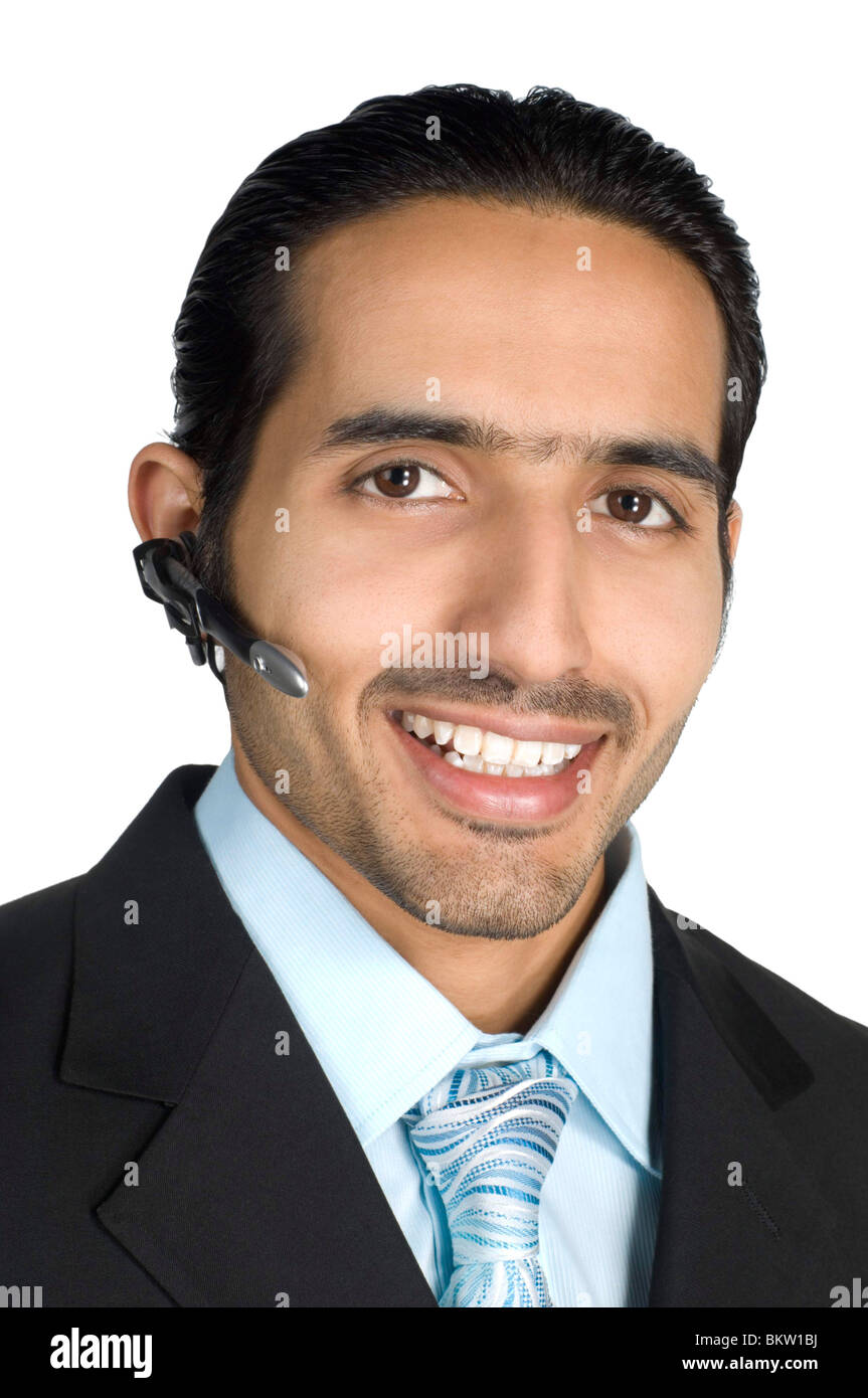 Businessman wearing Bluetooth, smiling Stock Photo - Alamy