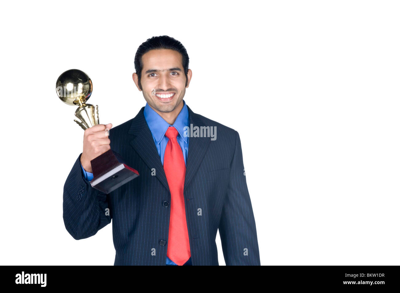 Businessman holding trophy, smiling, portrait Stock Photo - Alamy