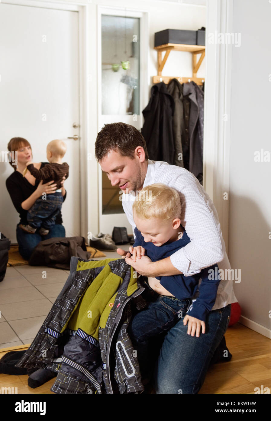 Child putting on jacket hi-res stock photography and images - Alamy