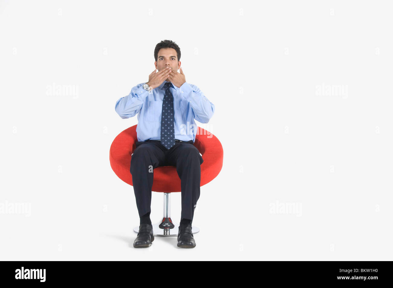 Young man covering mouth face Cut Out Stock Images & Pictures - Alamy