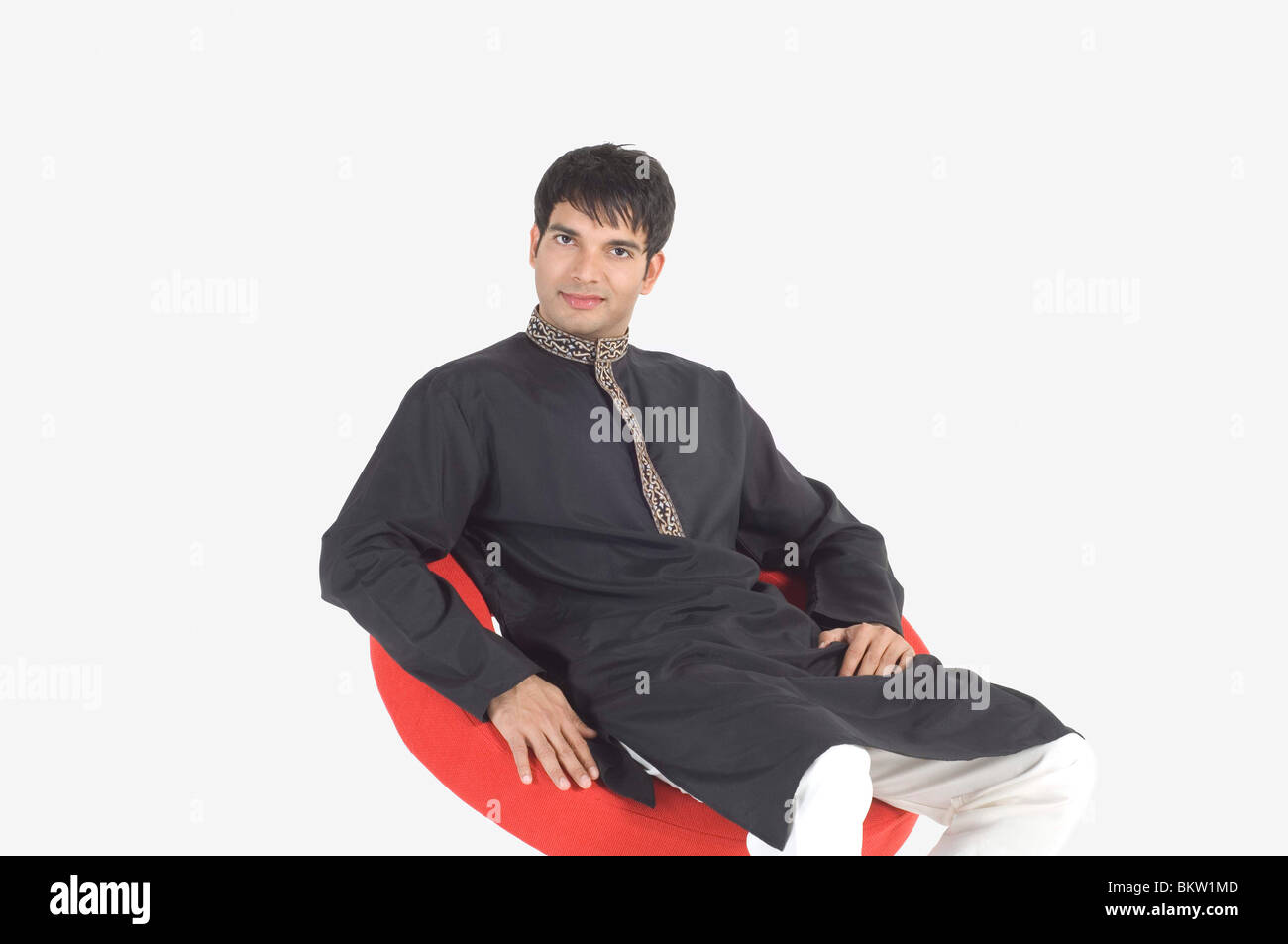 Young man sitting on swivel chair, portrait Stock Photo - Alamy